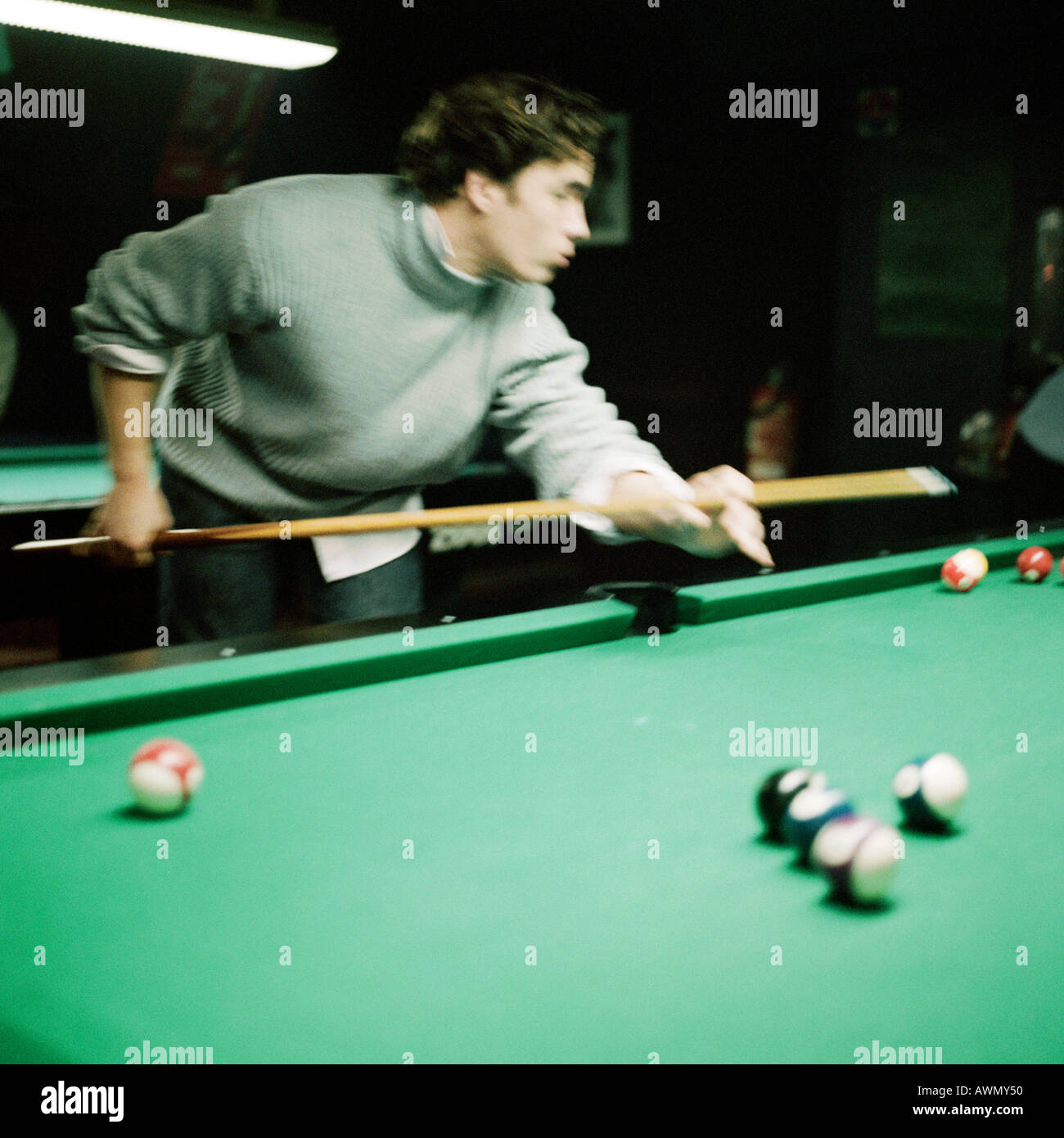 Young man shooting pool Stock Photo - Alamy