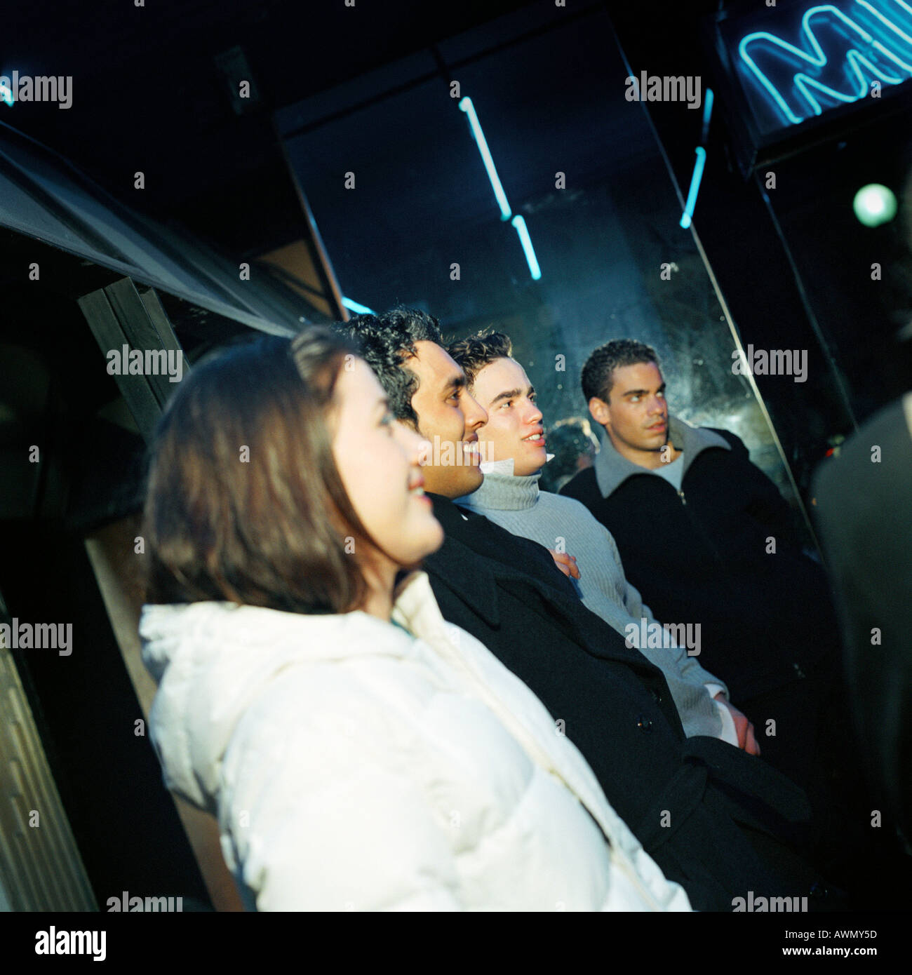 Group of young people standing, looking in same direction Stock Photo ...