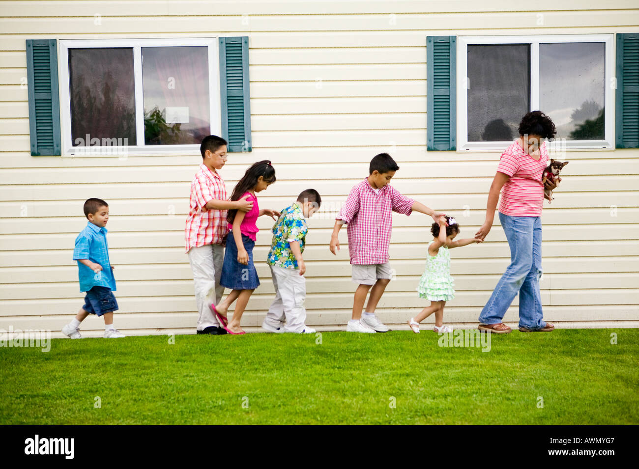 Children walking next to house Stock Photo - Alamy