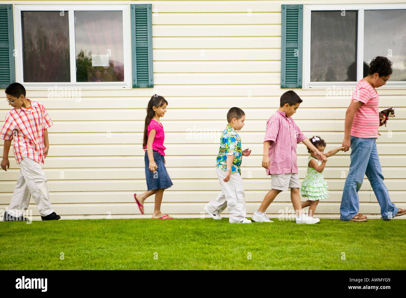 Children walking next to house Stock Photo - Alamy