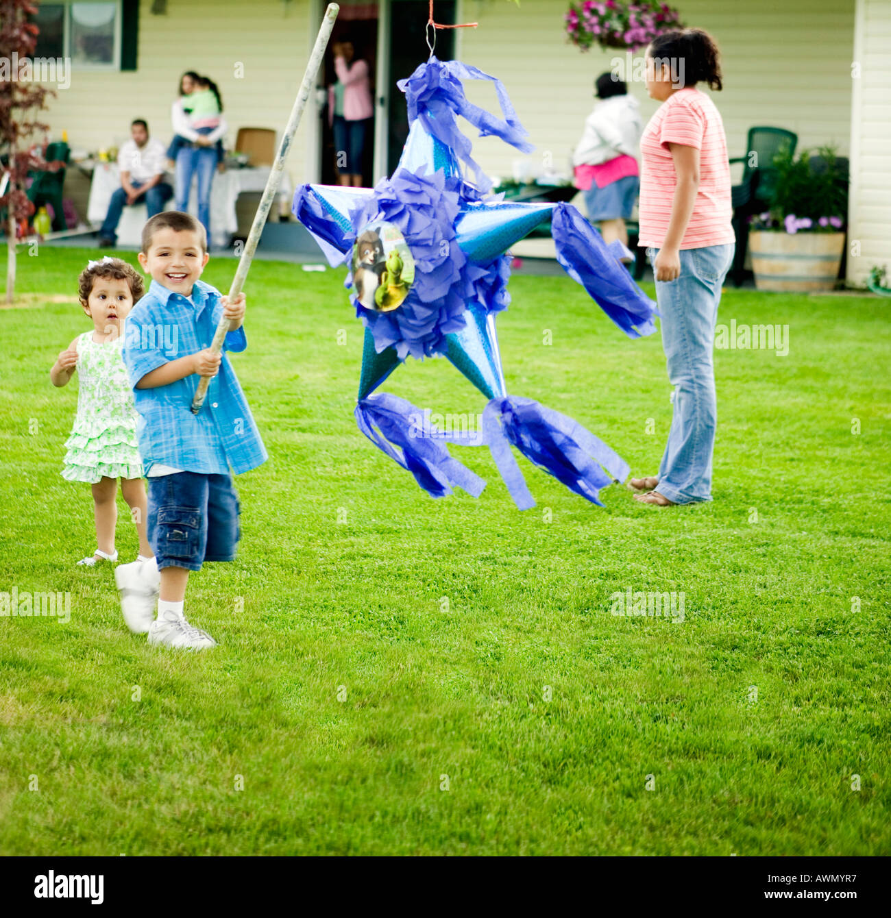 Hispanic boy hitting pinata Stock Photo - Alamy