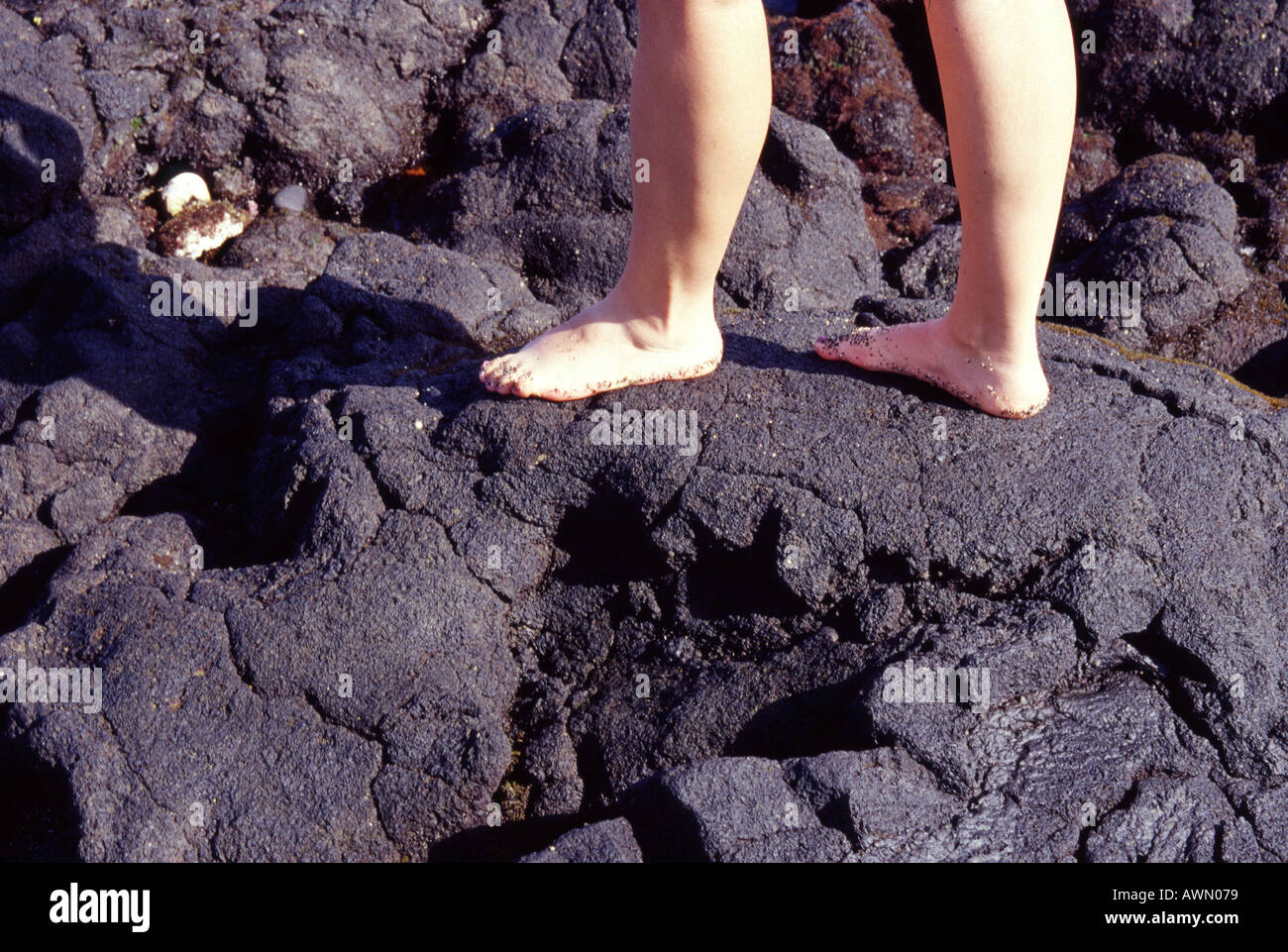 Feet on Volcanic Rock Stock Photo - Alamy
