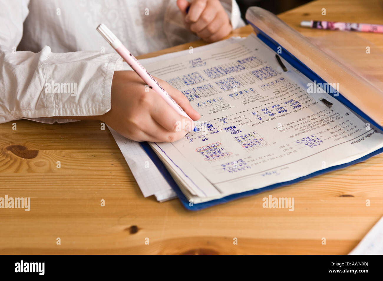 Young schoolgirl doing homework in nursery, mathematics exercises Stock ...