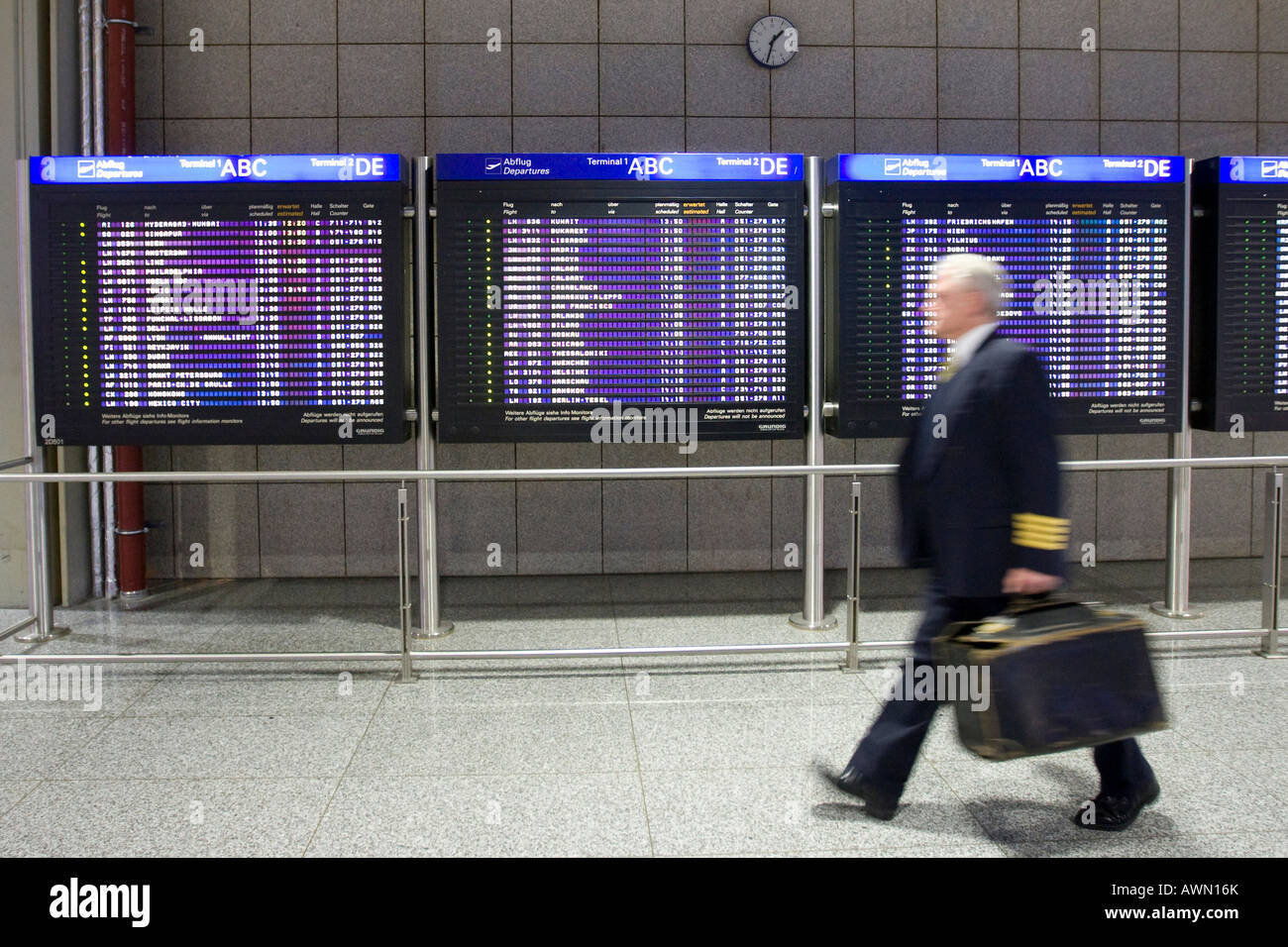 Pilot in front of flight info display screens, Terminal 2, Frankfurt ...