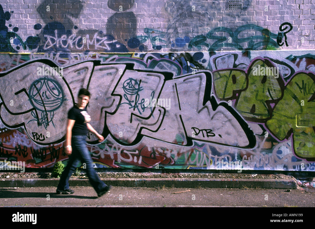 Walking past graffiti Stock Photo - Alamy
