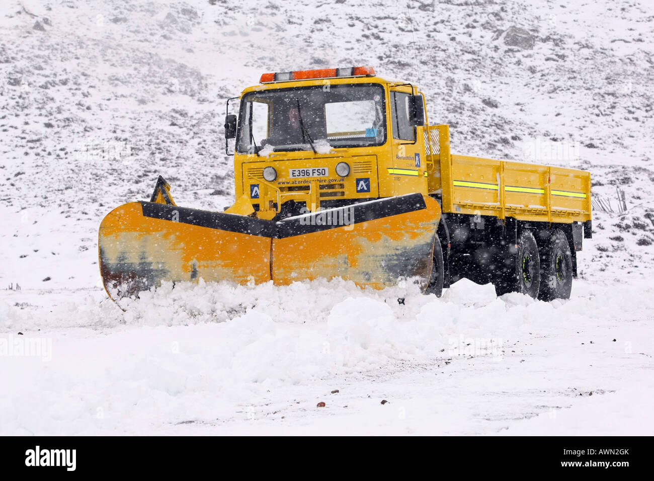 Aberdeenshire council yellow snowplough in deep snow in winter, near ...