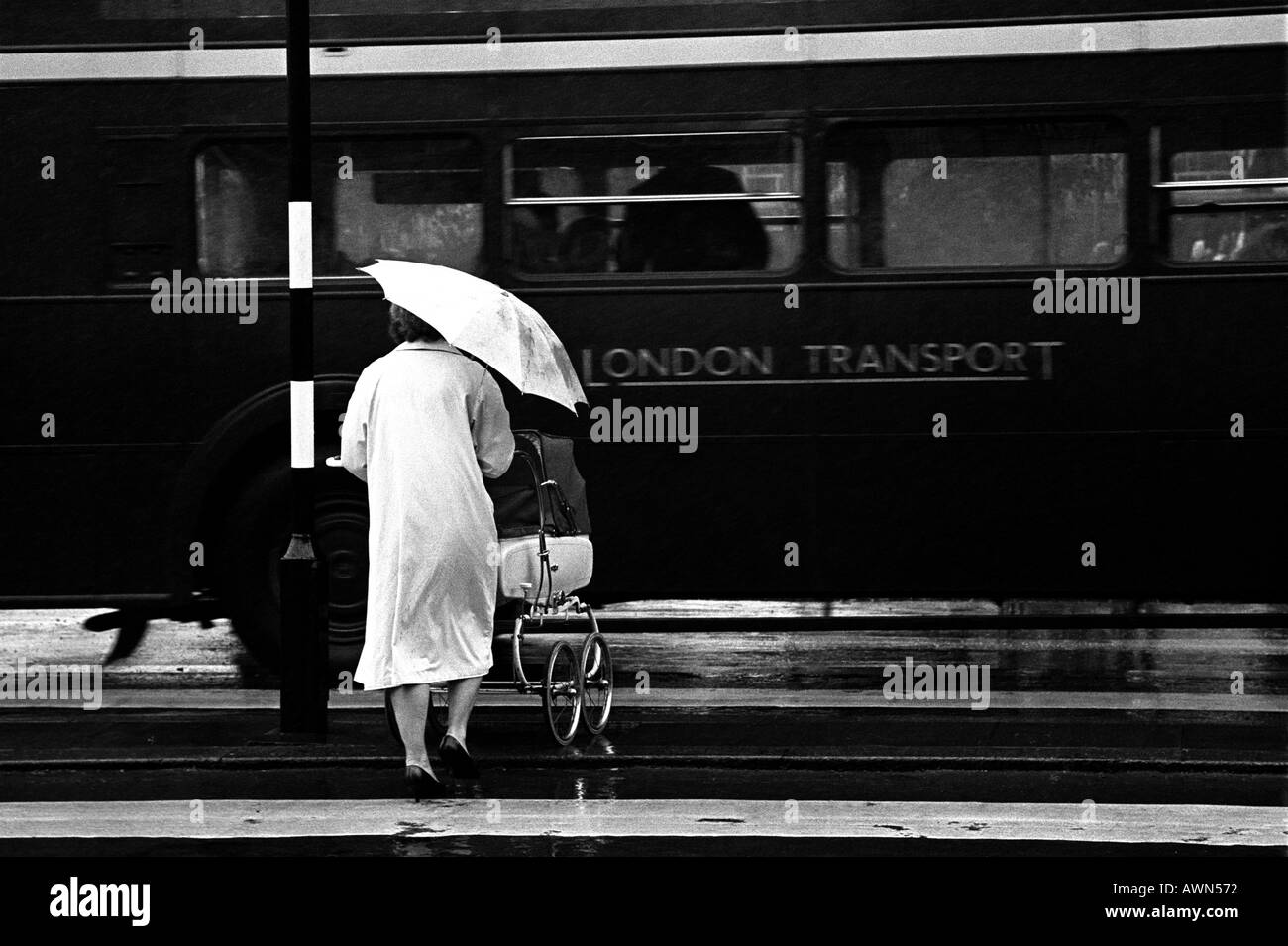 Woman crossing the road with a pram in the rain London Vintage 1964 ...