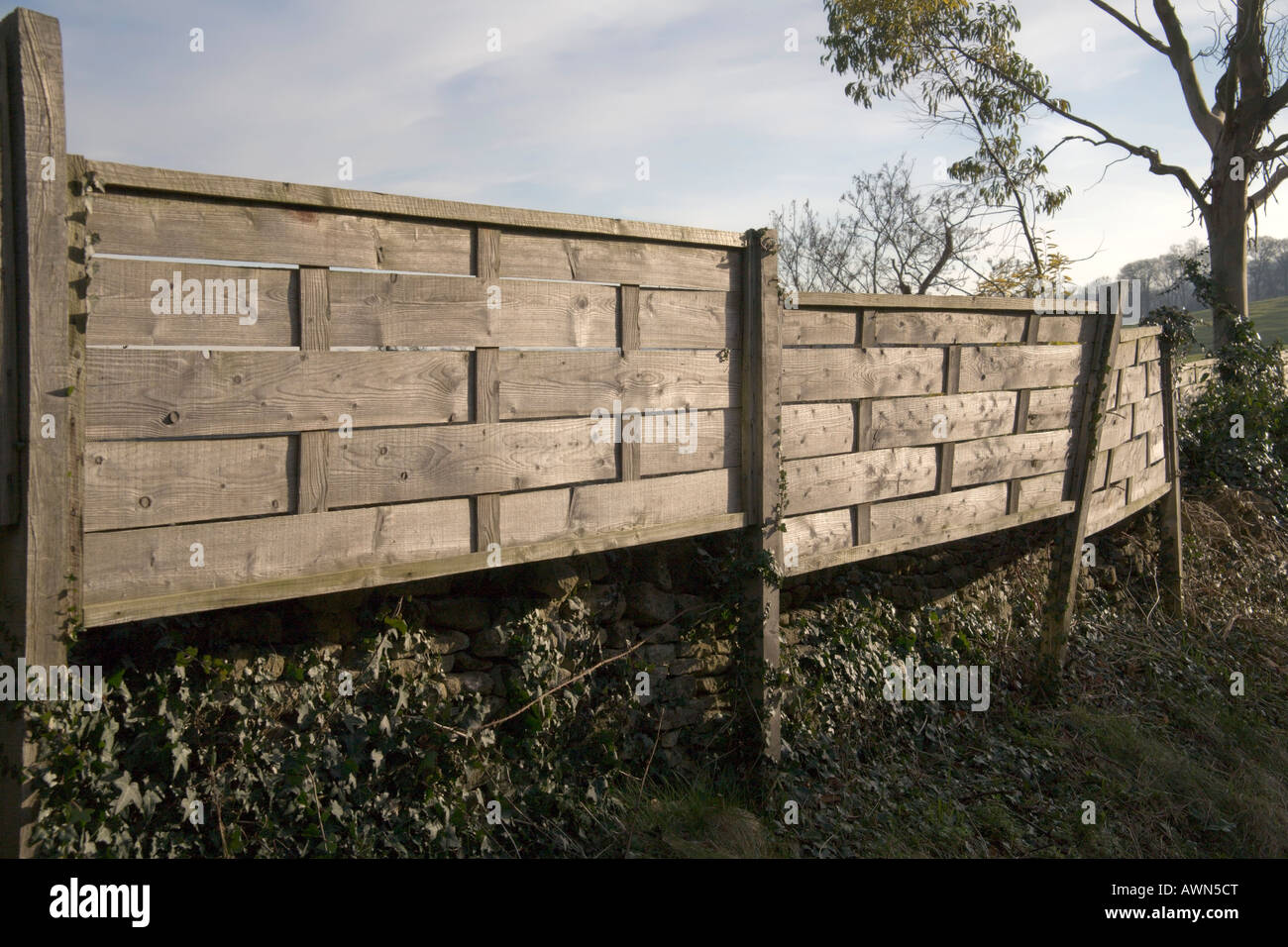A wooden fence dividing two properties houses yards Stock Photo - Alamy
