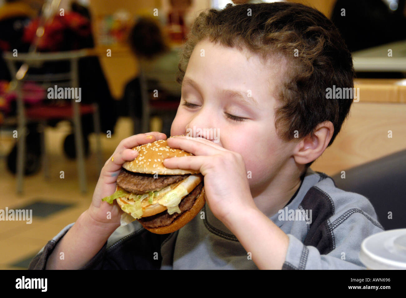 Small boy eating Mcdonald's Big Mac, England UK Stock Photo - Alamy