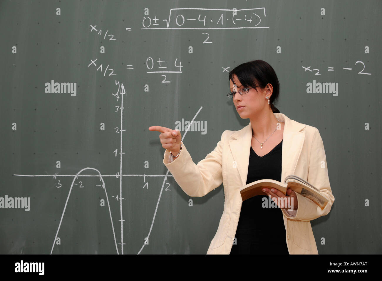 Young female teacher teaching maths Stock Photo - Alamy