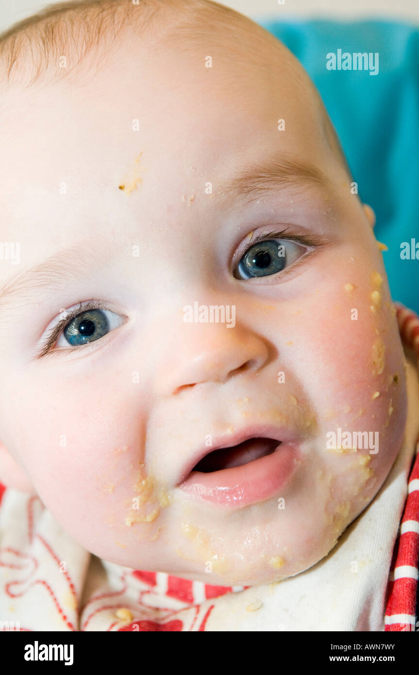 Baby boy with face covered in food Stock Photo - Alamy