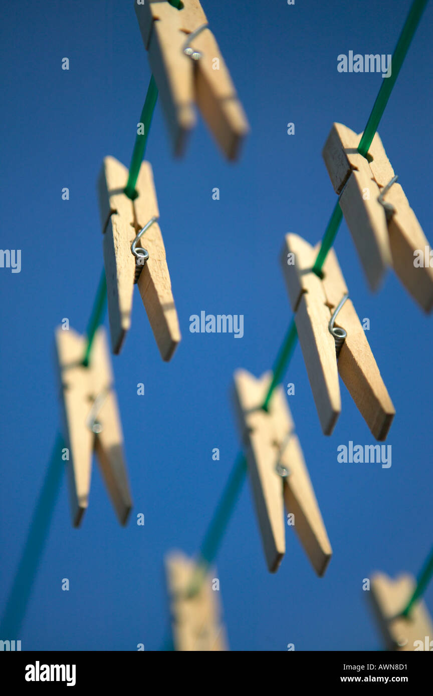 wooden clothes pegs on washing line Stock Photo - Alamy