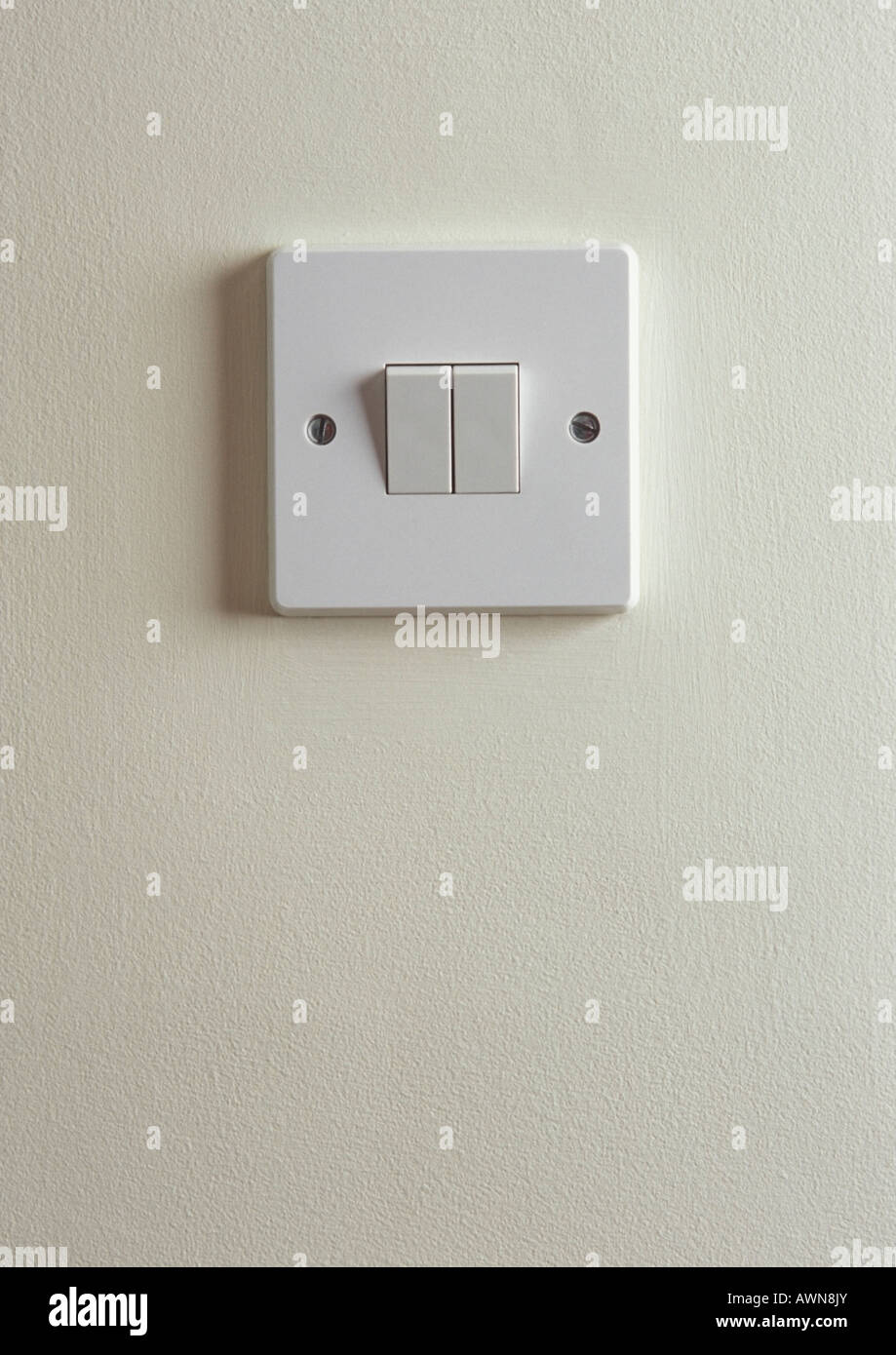 White plastic double light switch on white wall Stock Photo - Alamy