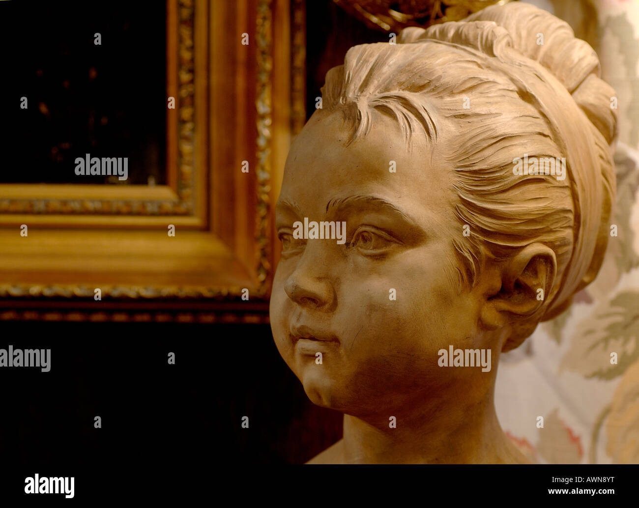 Child's bust modeled from clay, portrait of a child's head in front of ...