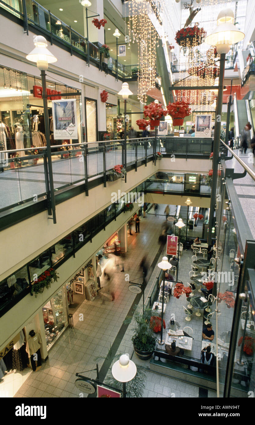 Underground shopping mall. Storeys of shops. Restaurant. Glass roof ...