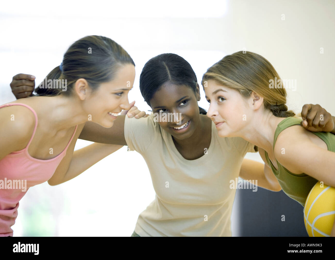 Teen girls huddling with basketball Stock Photo - Alamy