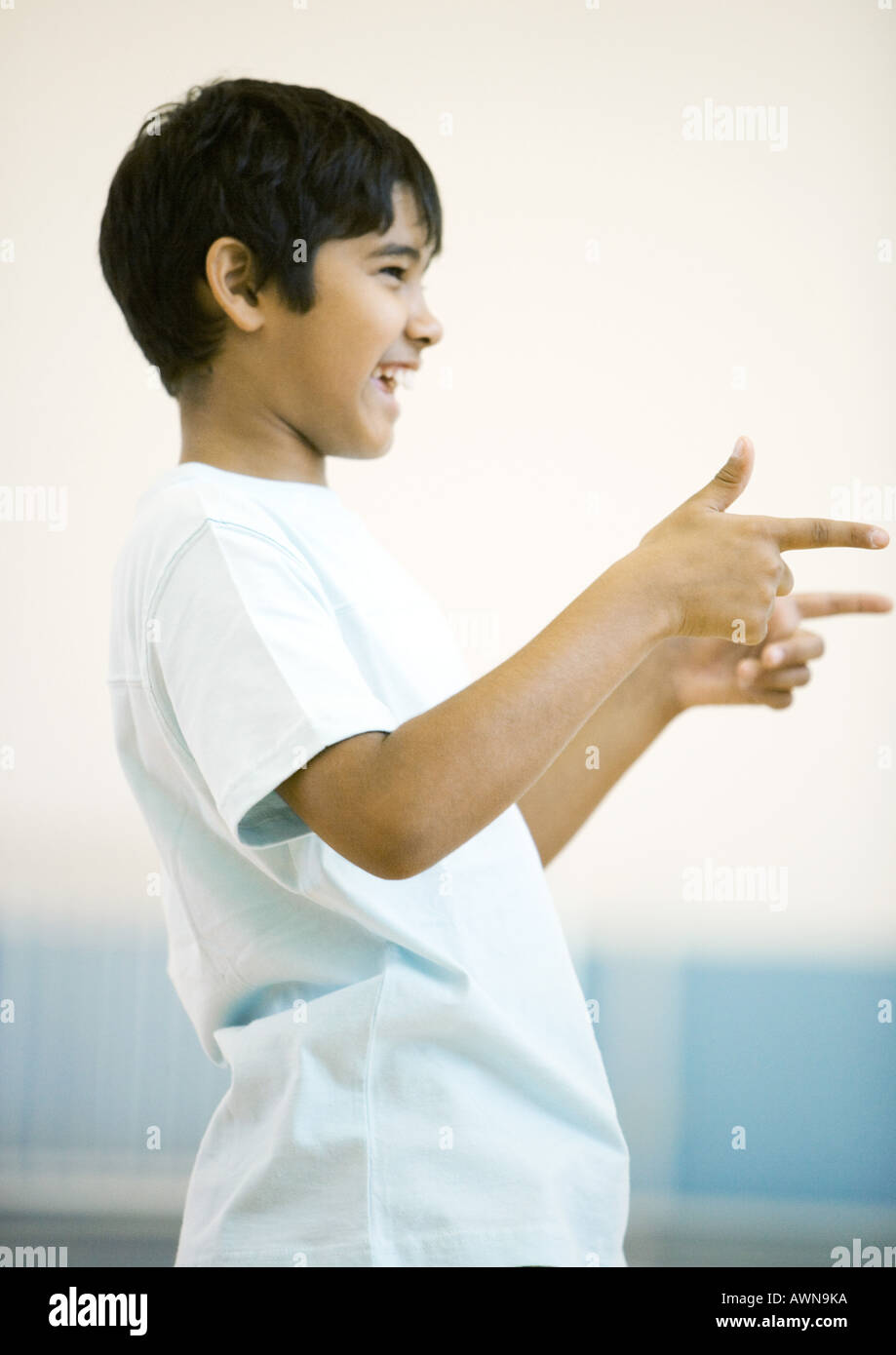 Teen boy pointing with both hands, smiling Stock Photo - Alamy