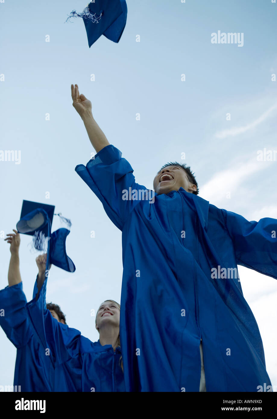 Graduates throwing caps Stock Photo - Alamy