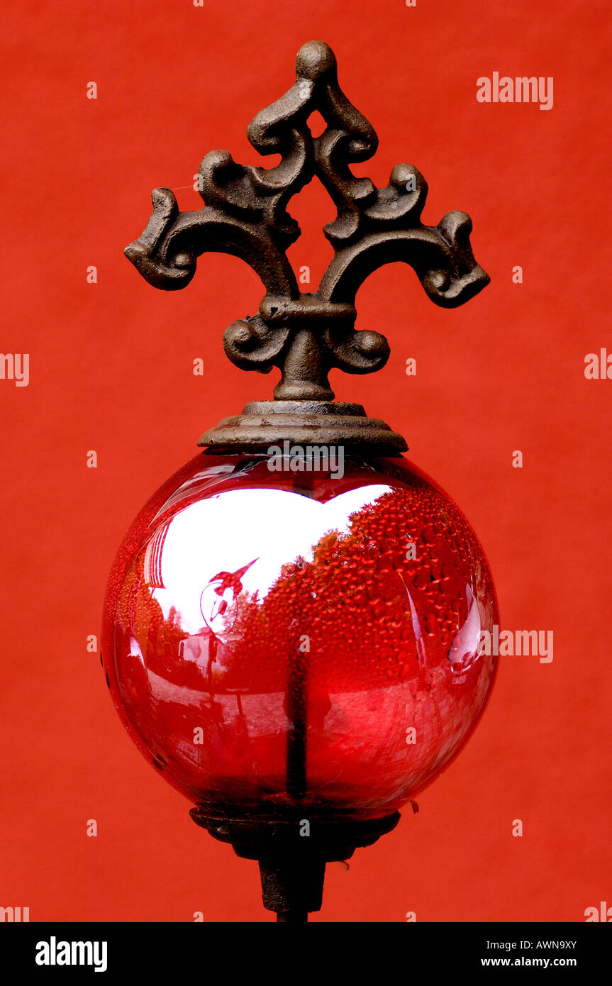 Iron sphere decorated with cast iron, red background Stock Photo - Alamy