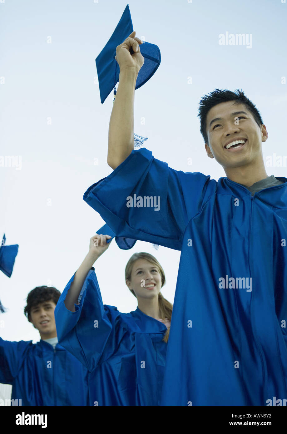 Graduates taking off caps Stock Photo - Alamy