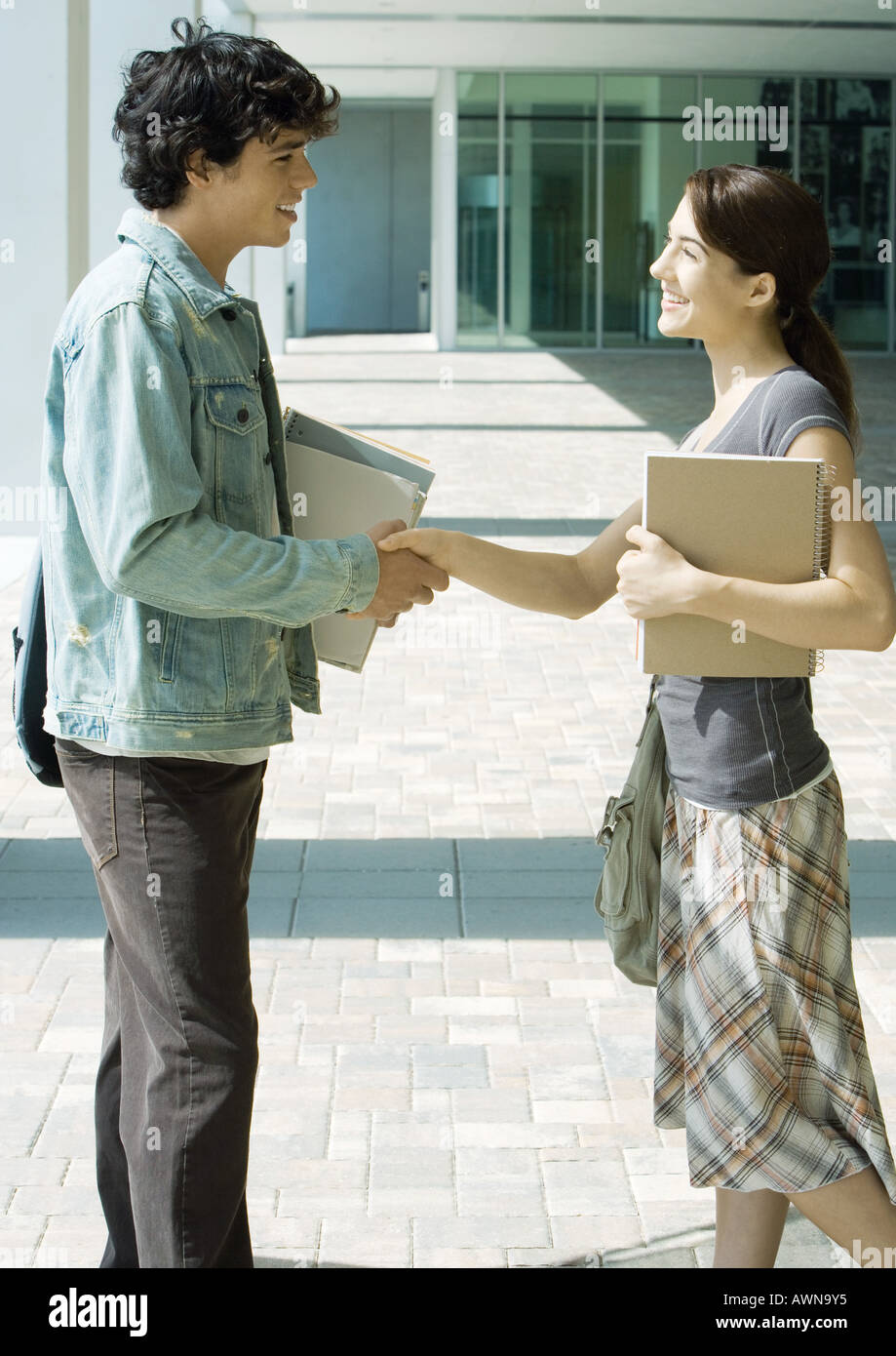 Students shaking hands on campus Stock Photo - Alamy