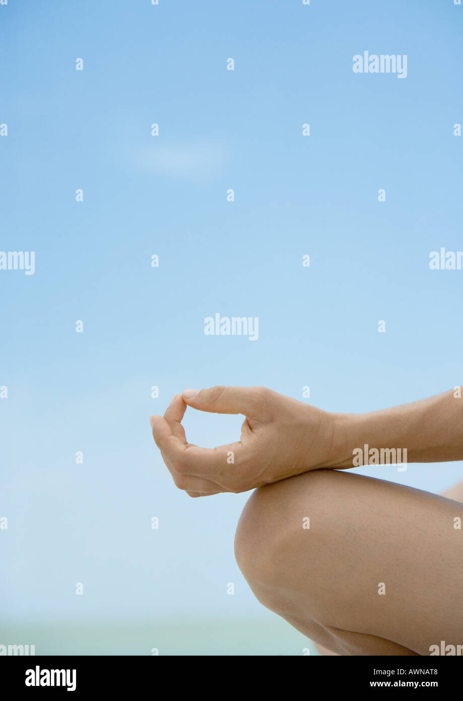 Woman's hand and knee, lotus position, close-up Stock Photo - Alamy