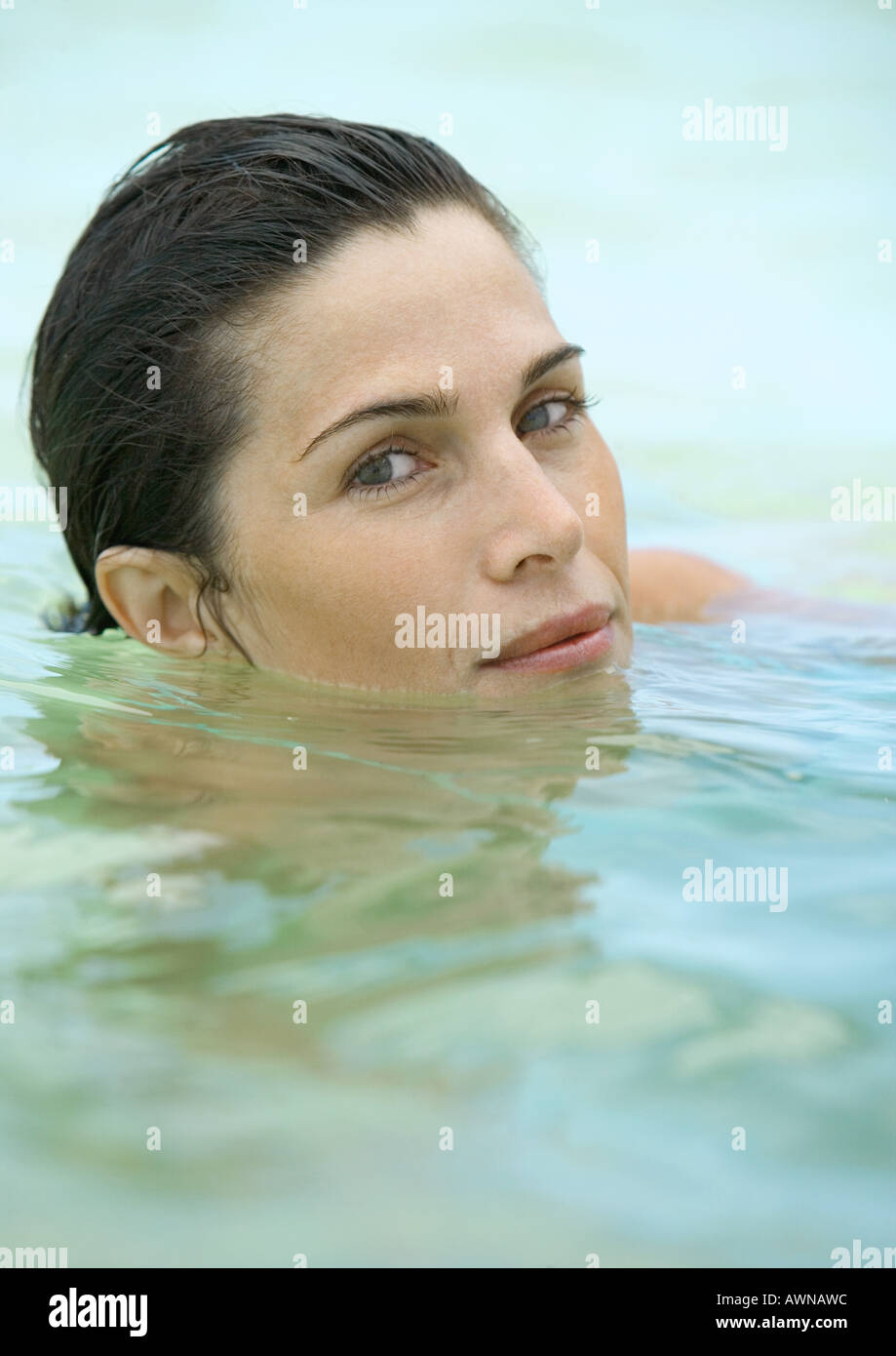 Woman in water, looking at camera Stock Photo - Alamy