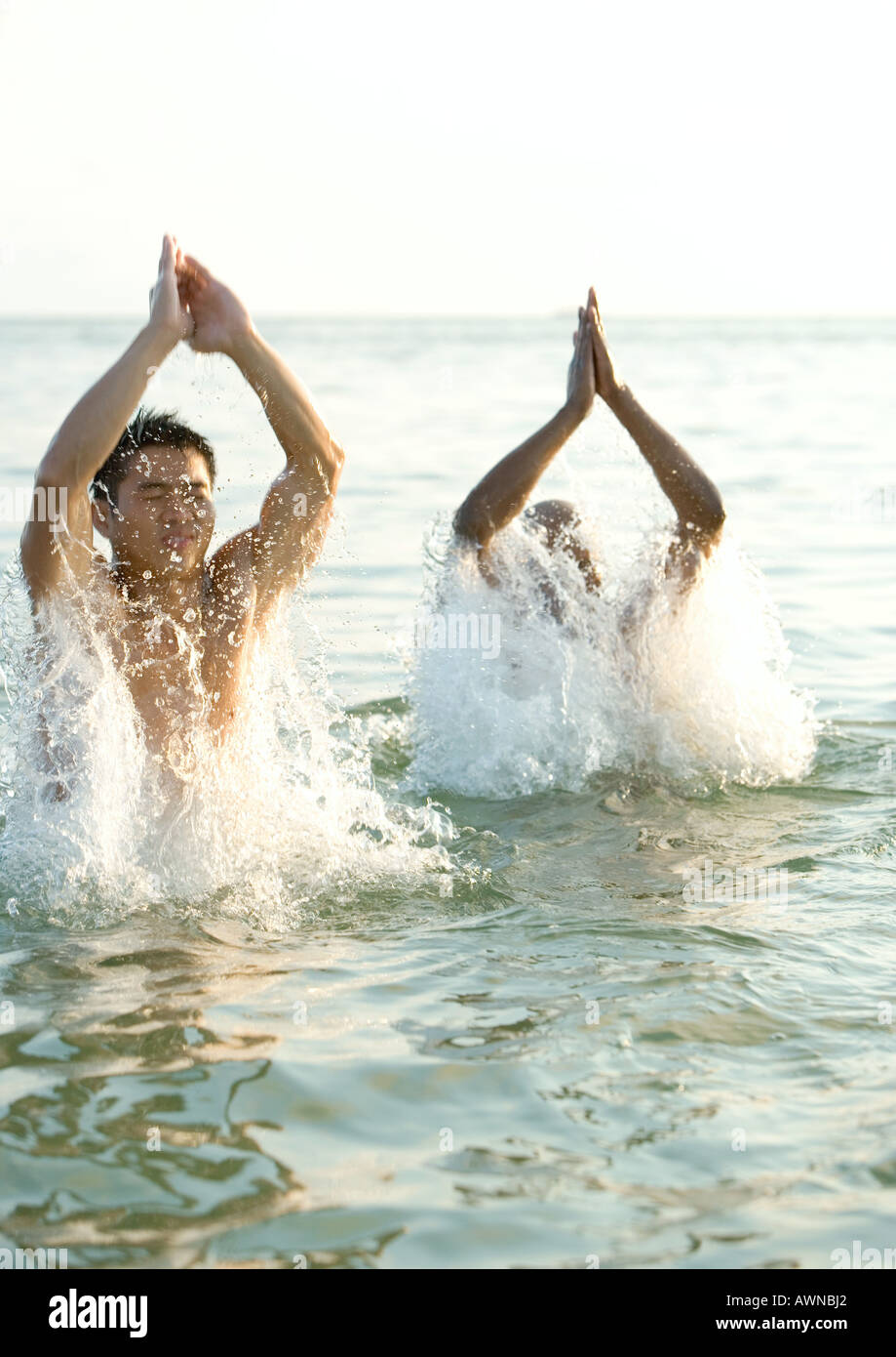 Two men emerging from water Stock Photo - Alamy