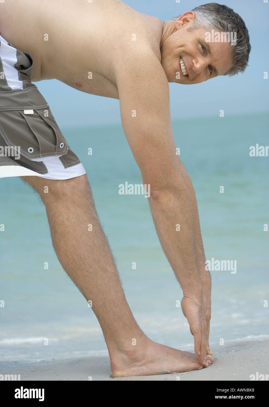 Man touching toes Stock Photo - Alamy