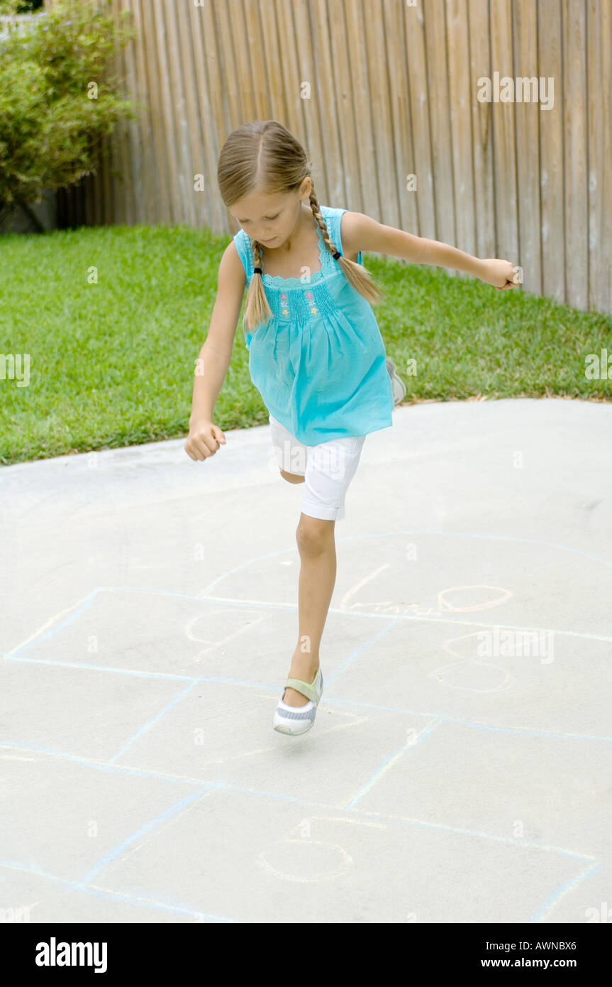 Girl playing hopscotch Stock Photo - Alamy
