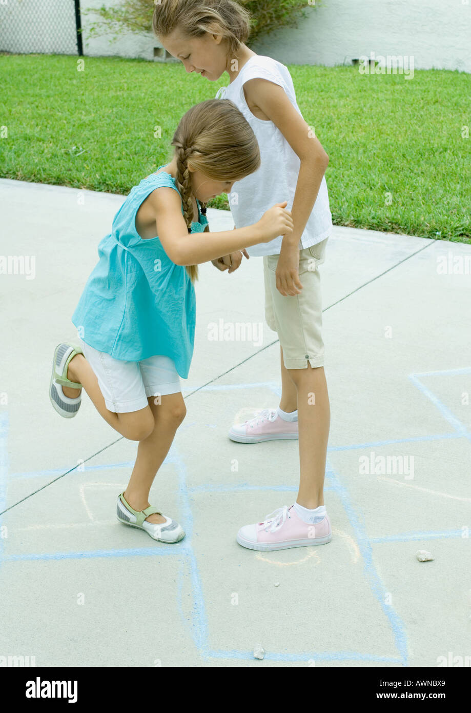 Girls playing hopscotch Stock Photo - Alamy