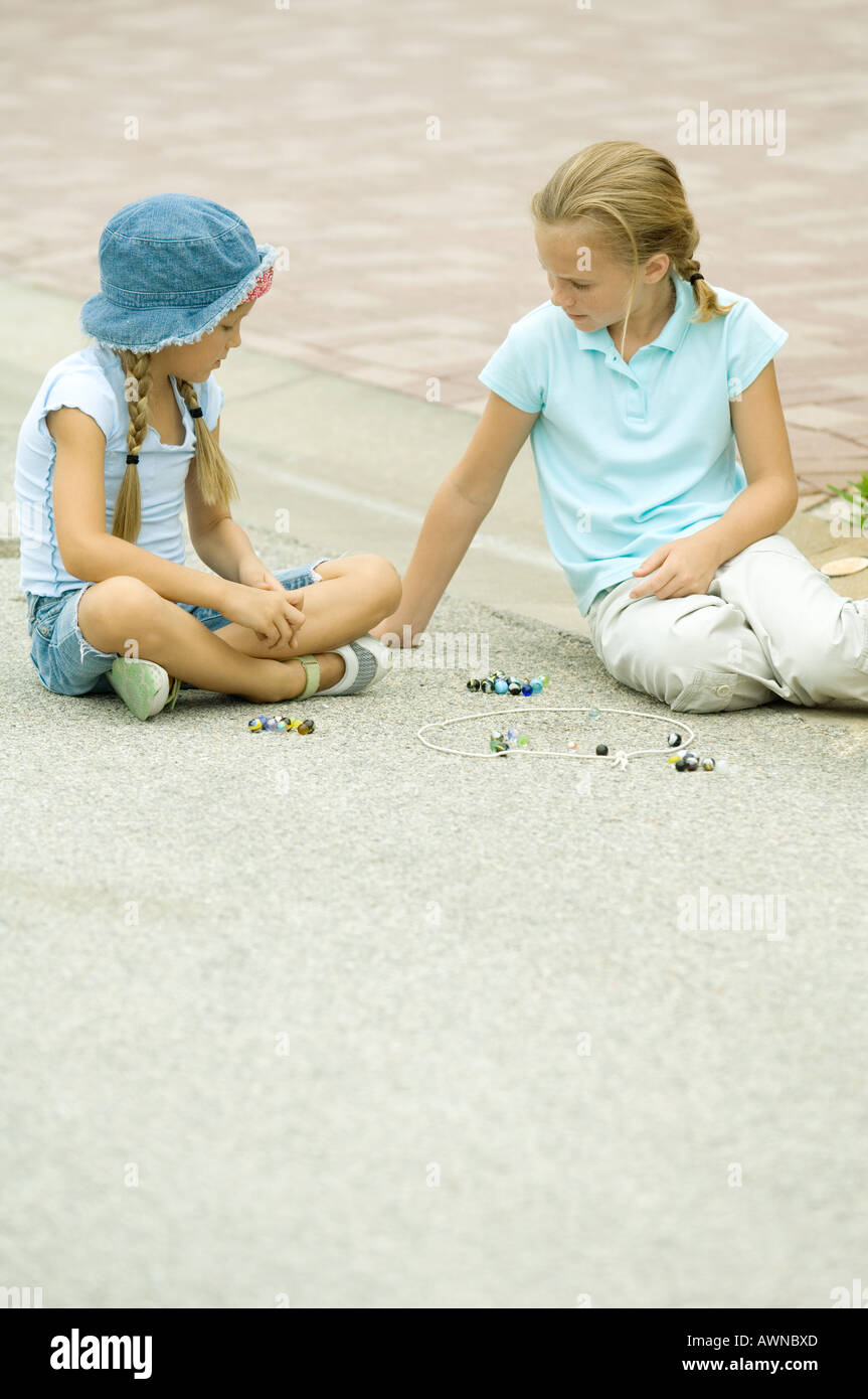 Two children playing marbles hi-res stock photography and images - Alamy