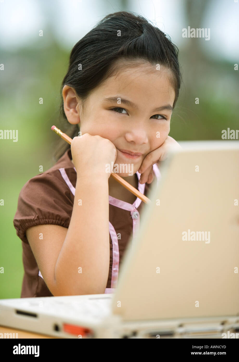 Girl using laptop, smiling Stock Photo - Alamy