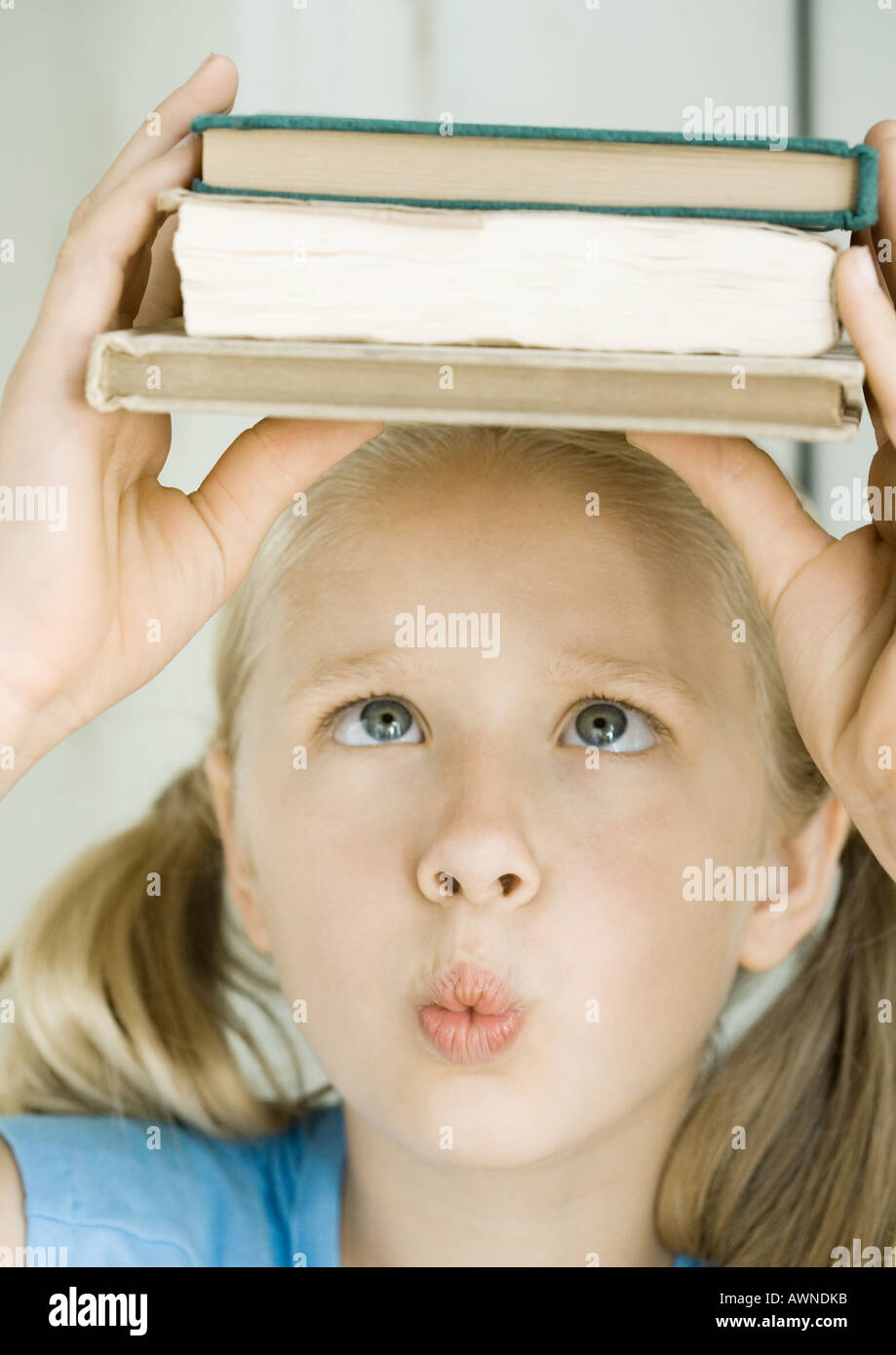 Children balancing book on head hi-res stock photography and images - Alamy