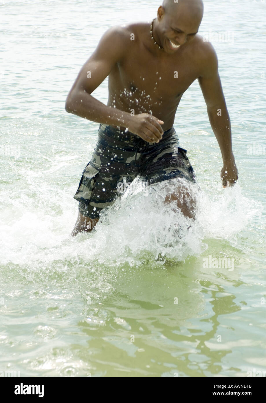 Man splashing in water Stock Photo - Alamy