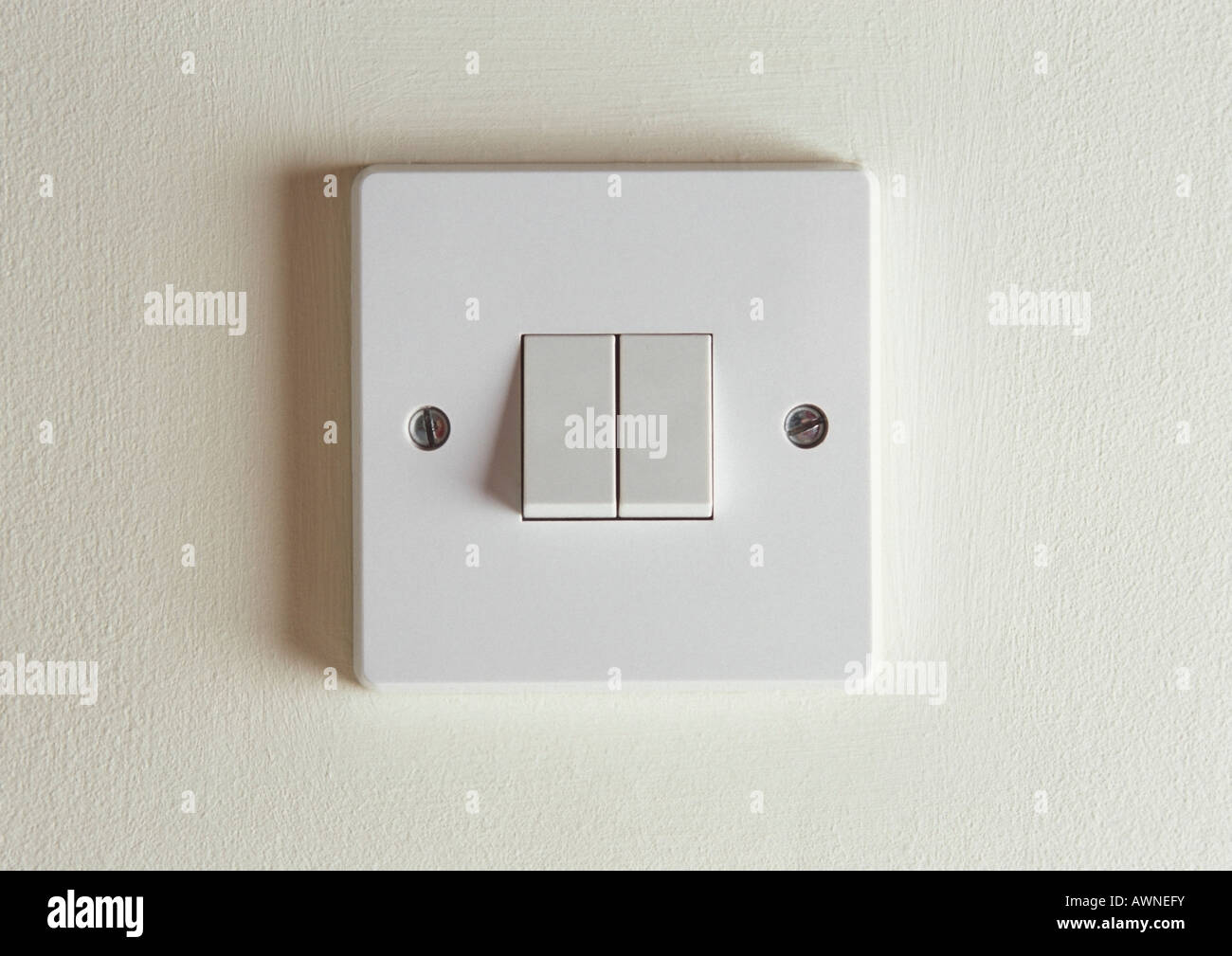 White plastic double light switch on white wall Stock Photo - Alamy