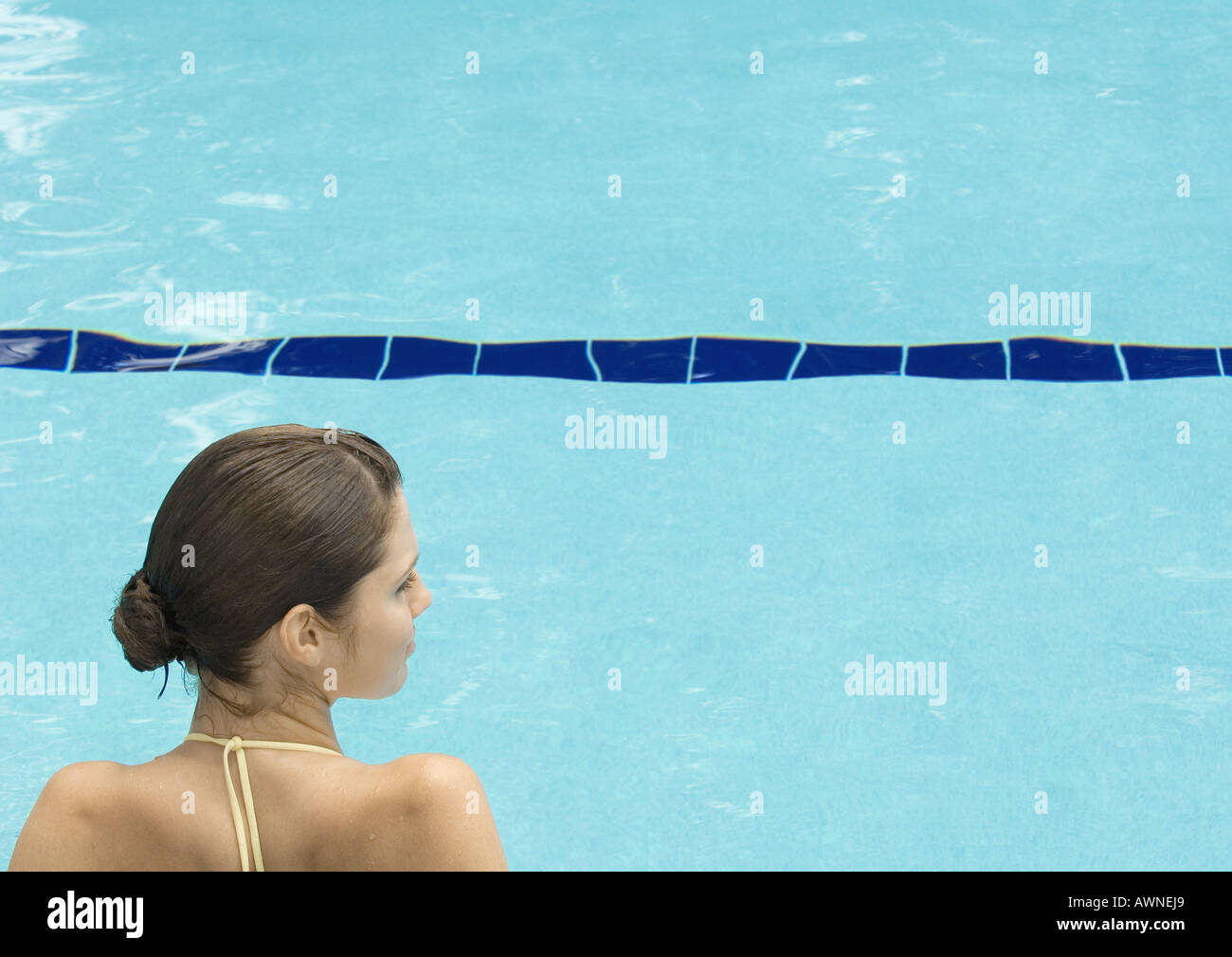 Woman by pool, head and shoulders, rear view Stock Photo - Alamy