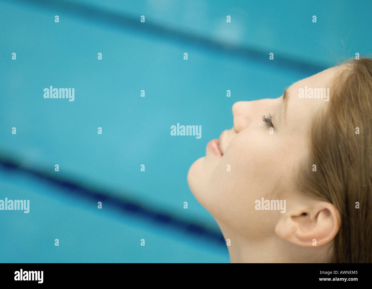 Woman smiling, close-up of side view of face, pool in background Stock ...
