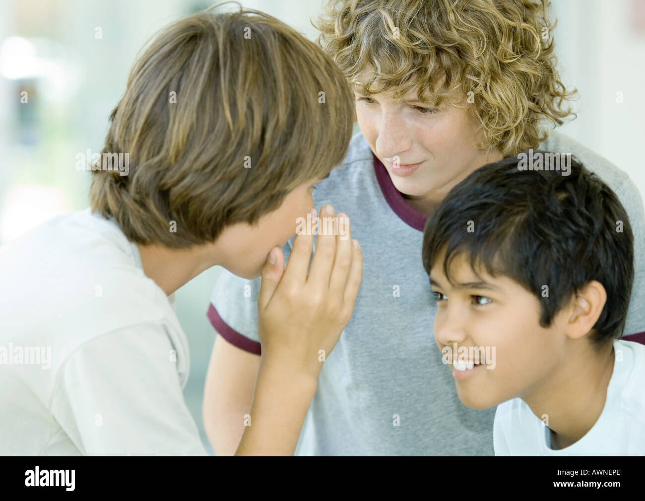 Three boy whispering hi-res stock photography and images - Alamy