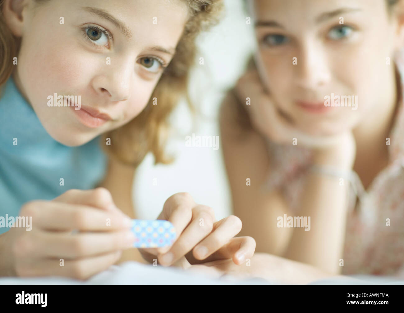 Preteen girls filing nails Stock Photo - Alamy