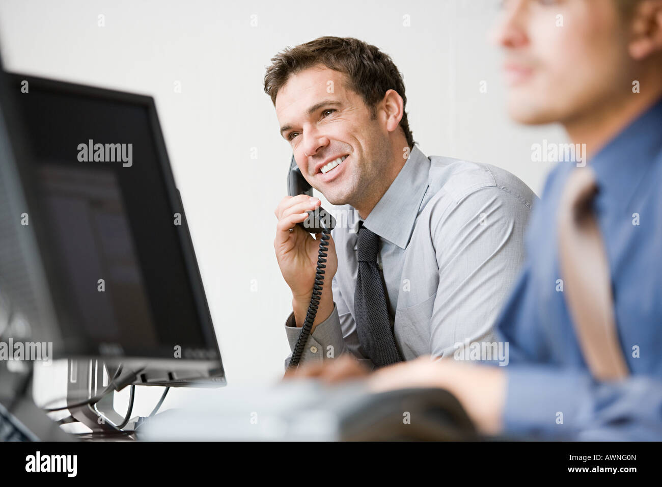 Businessman using a telephone Stock Photo - Alamy