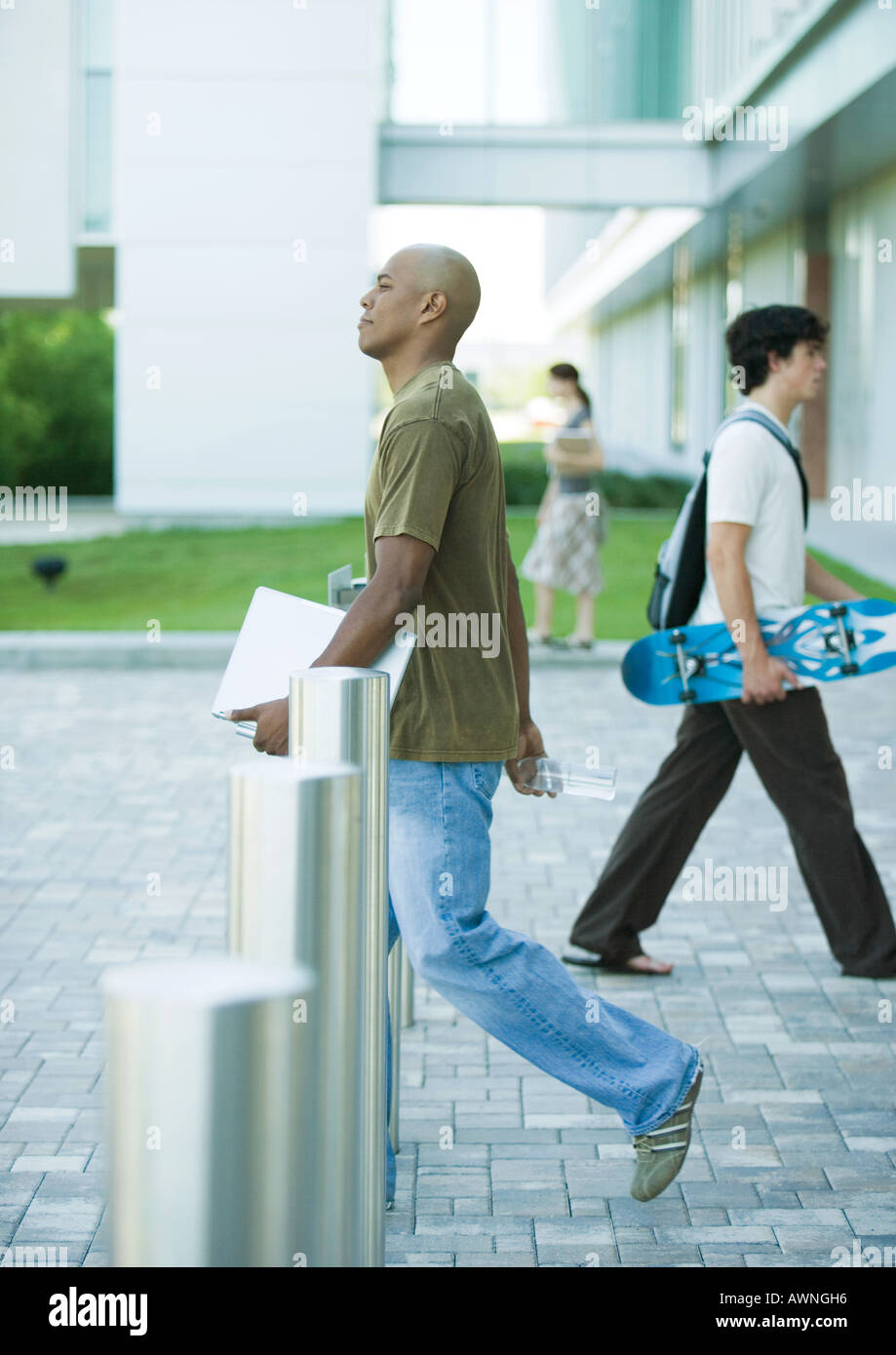 University student carrying laptop smiling hi-res stock photography and ...
