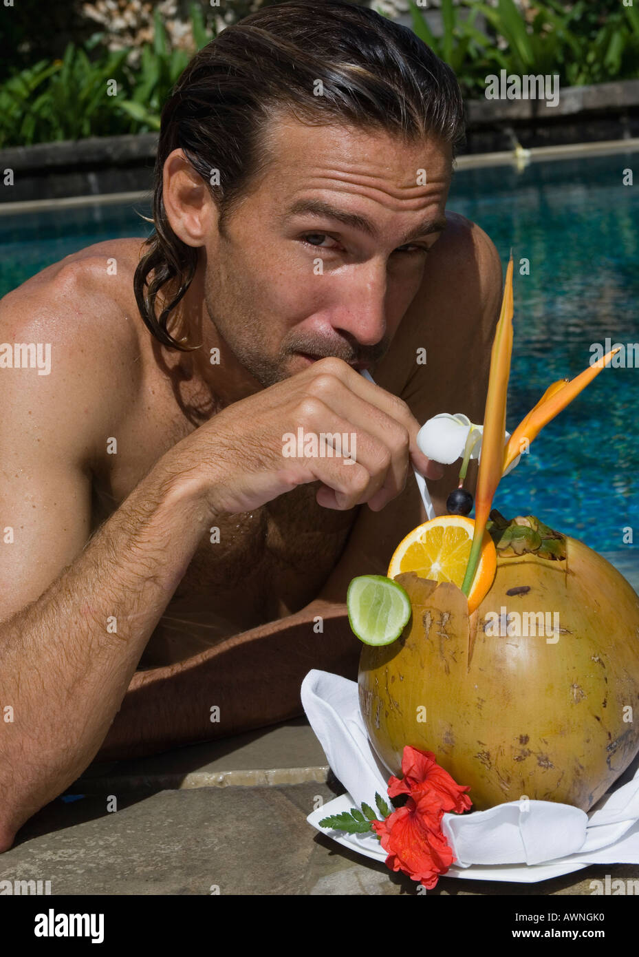 man drinking by poolside Stock Photo - Alamy