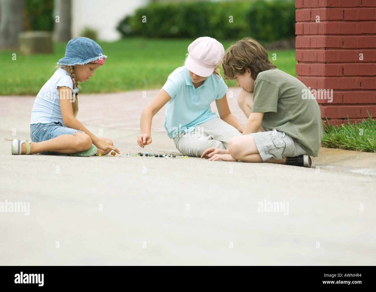 Children playing marbles in street Stock Photo - Alamy