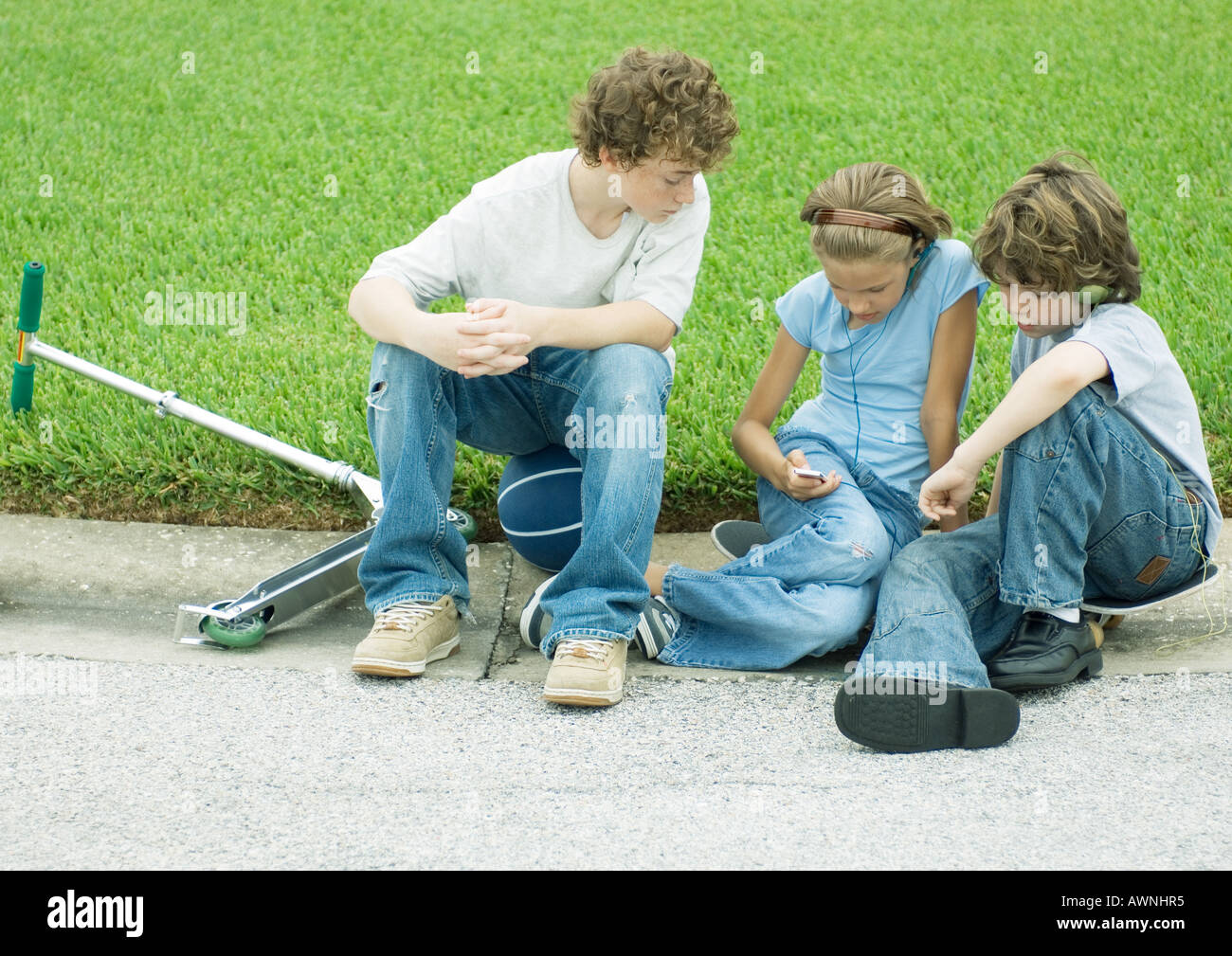 Kids sitting on curb on hi-res stock photography and images - Alamy