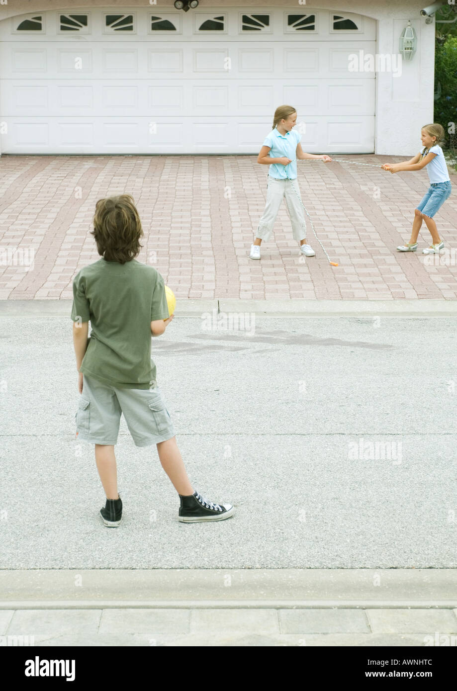 Suburban children playing in driveway Stock Photo - Alamy