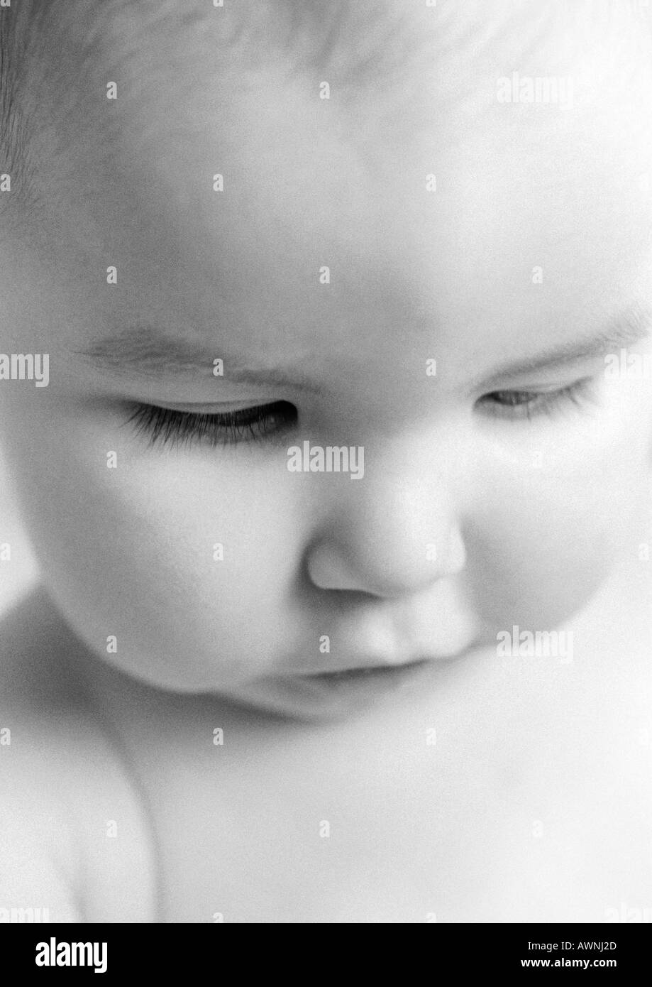 Baby looking down, close-up, B&W Stock Photo - Alamy