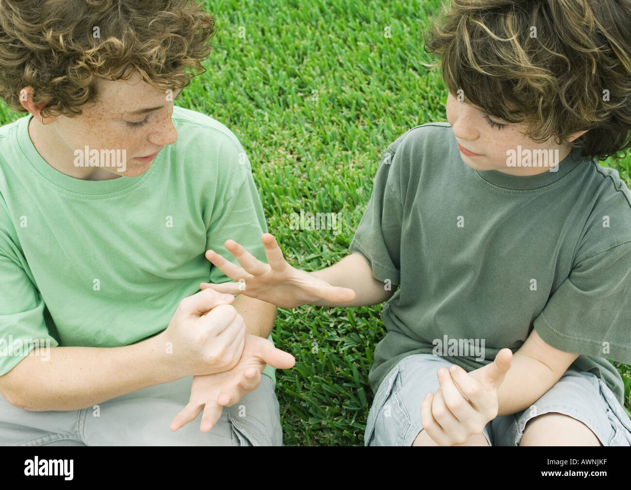 Two boys playing rock paper scissors Stock Photo - Alamy