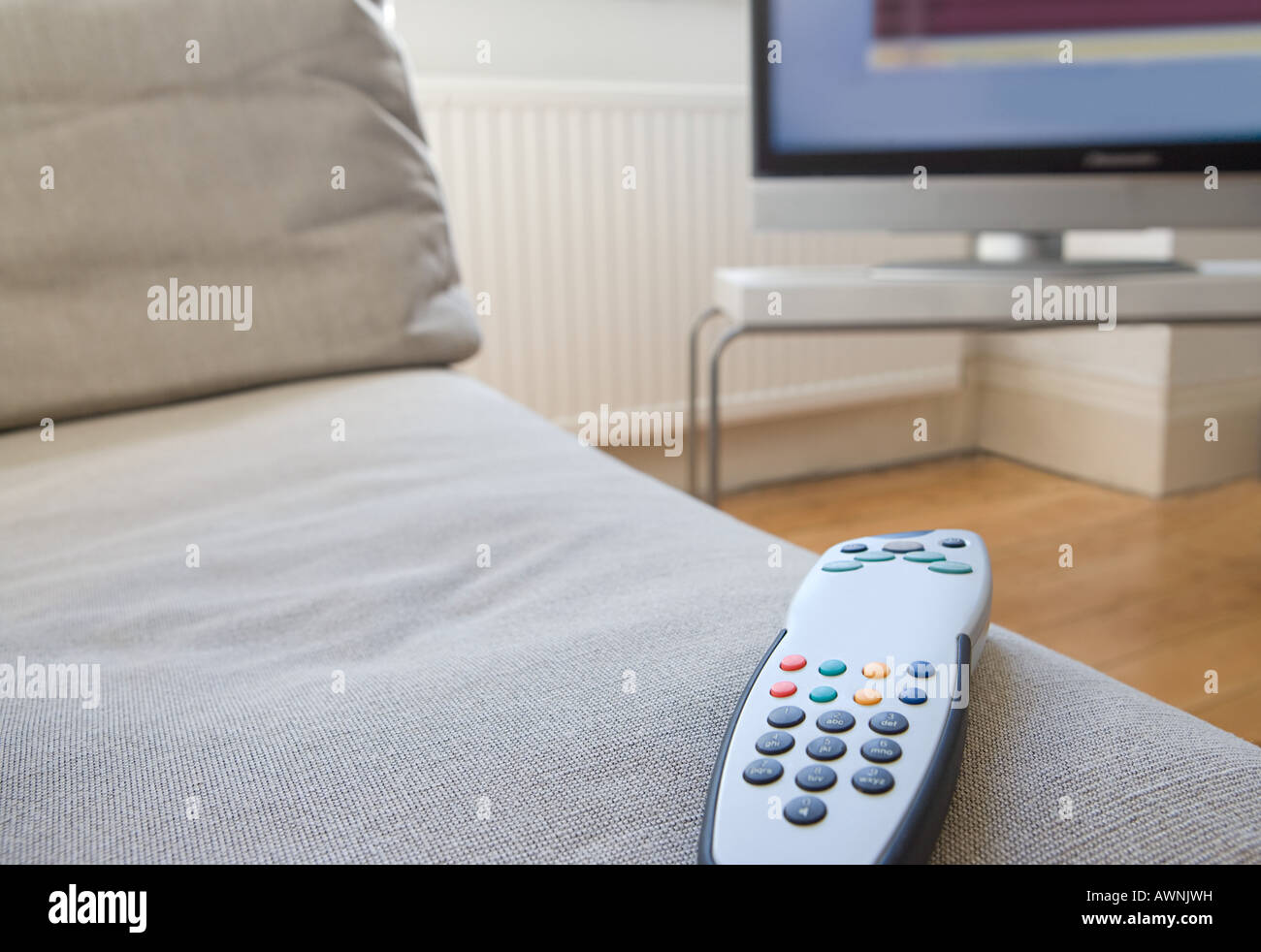 Remote control on a sofa Stock Photo - Alamy