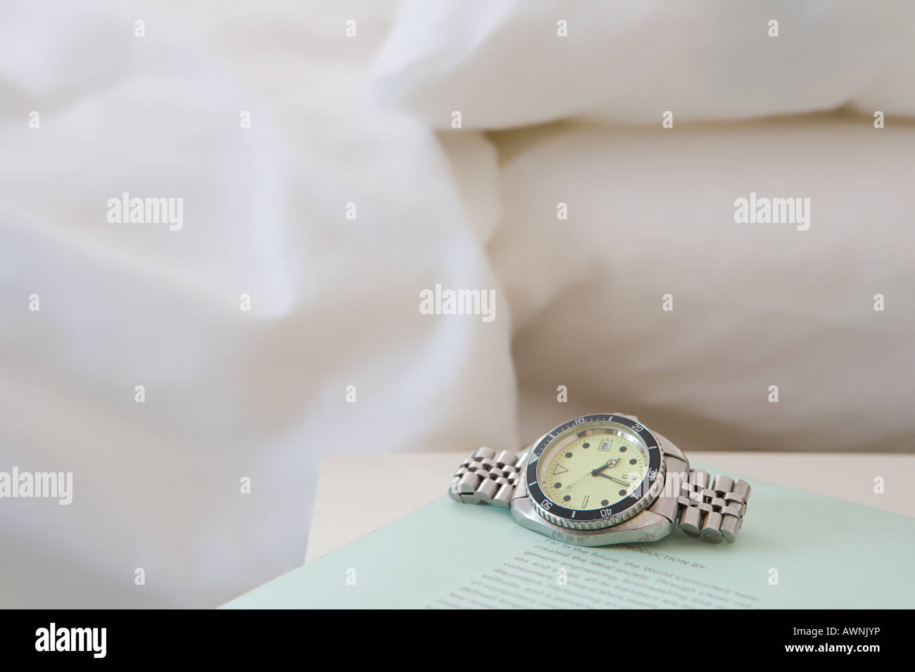A watch on a book Stock Photo - Alamy